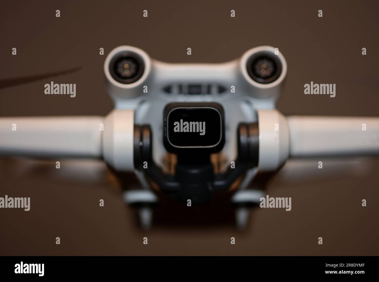 The drone copter flying with digital camera isolated on empty colorful ...