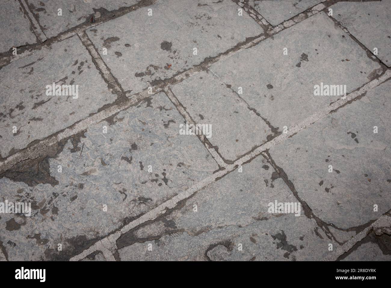 Typical pattern of concrete cobblestone path weathered and worn from ...