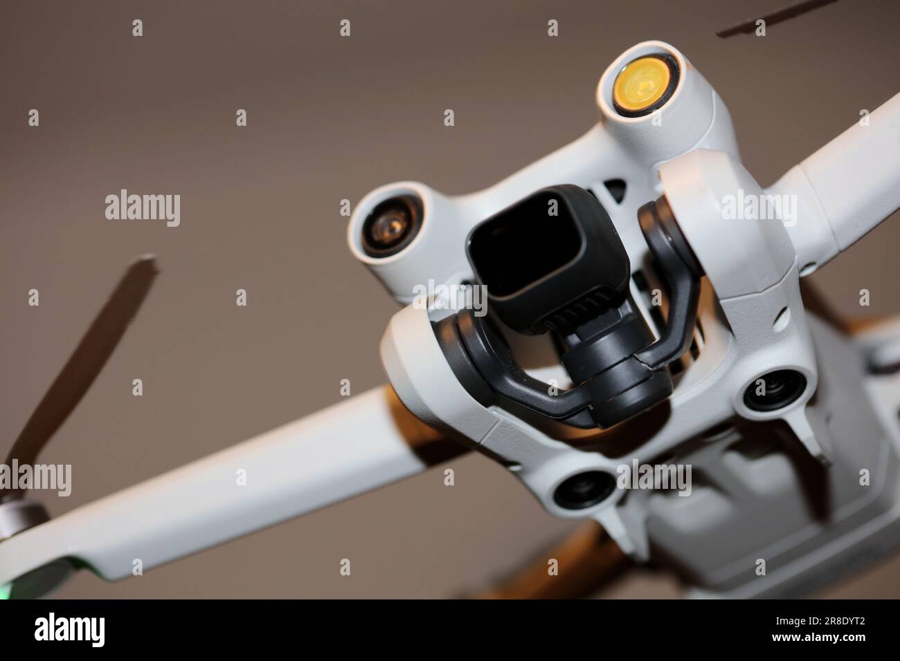 The drone copter flying with digital camera isolated on empty colorful ...