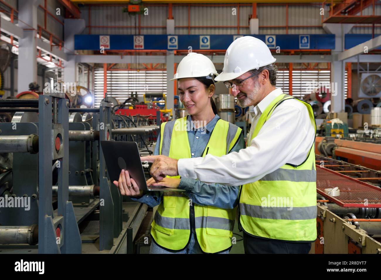 Senior engineer manager trains new employees within the metal sheet ...