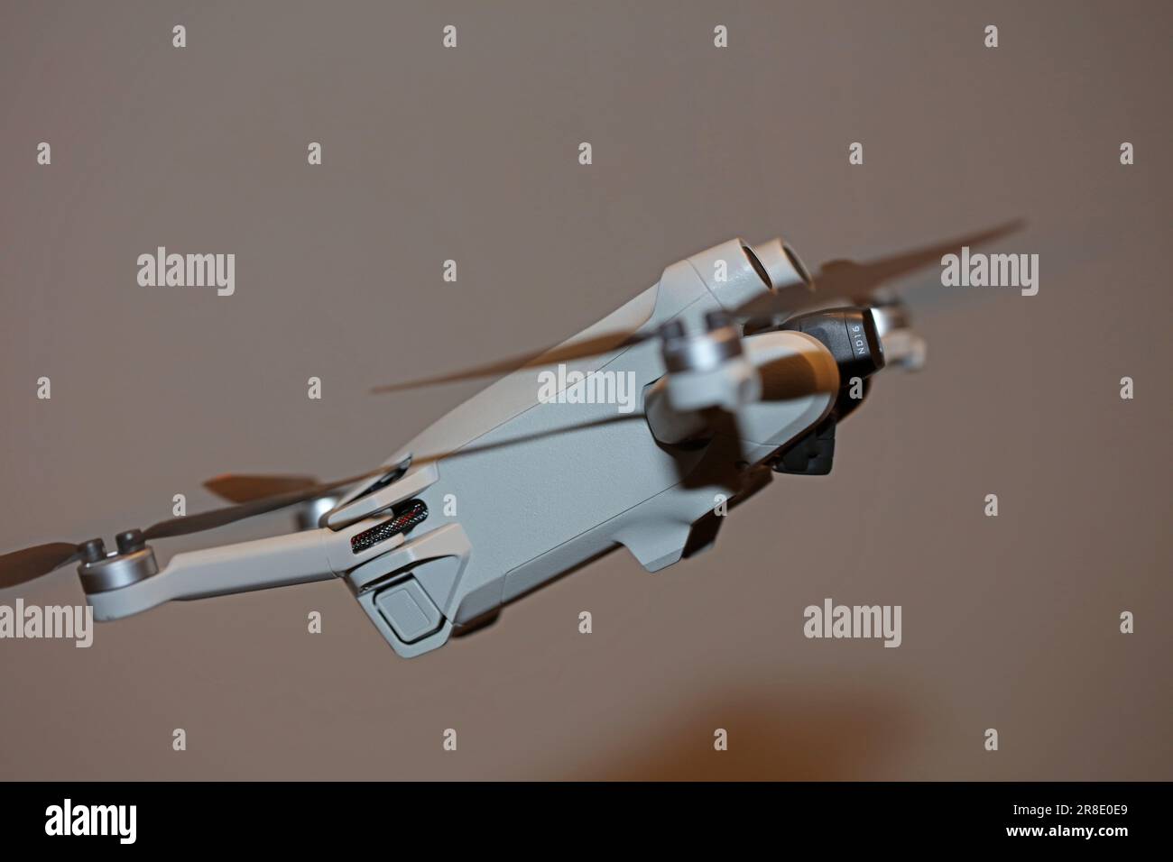 The drone copter flying with digital camera isolated on empty colorful ...