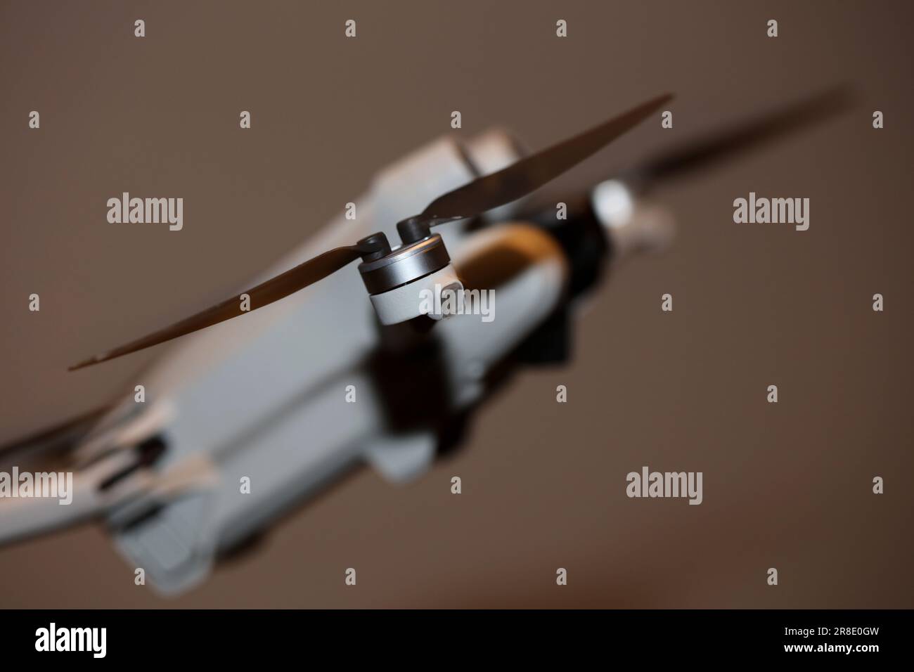 The drone copter flying with digital camera isolated on empty colorful ...