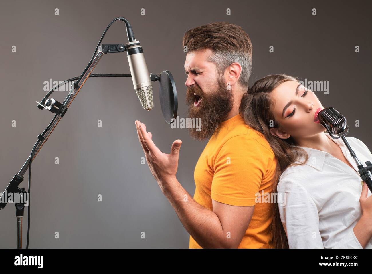 Couple singing. Coupl in recording studio. Music performance vocal ...