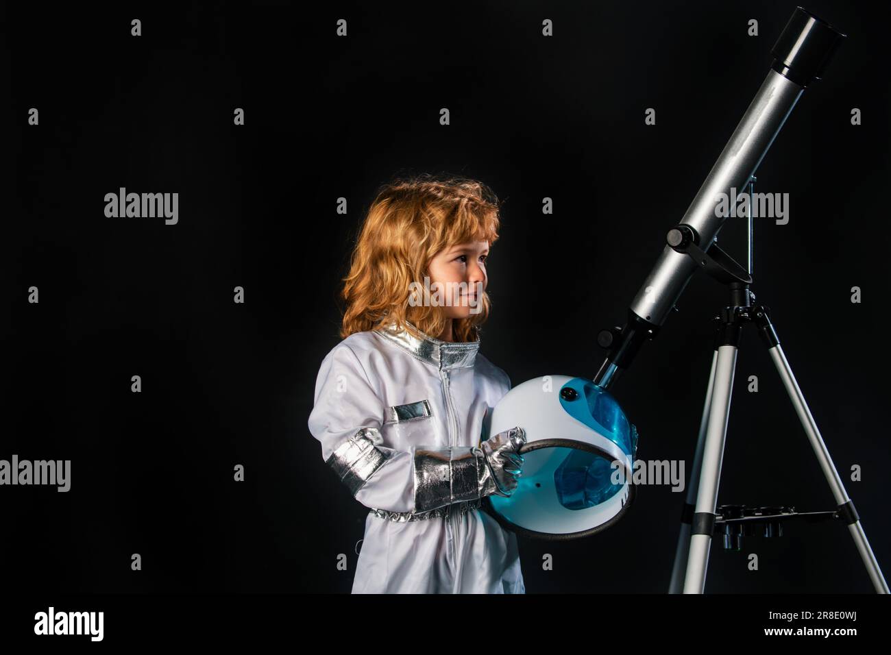 A little boy with telescope and space helmet dreams of becoming an ...