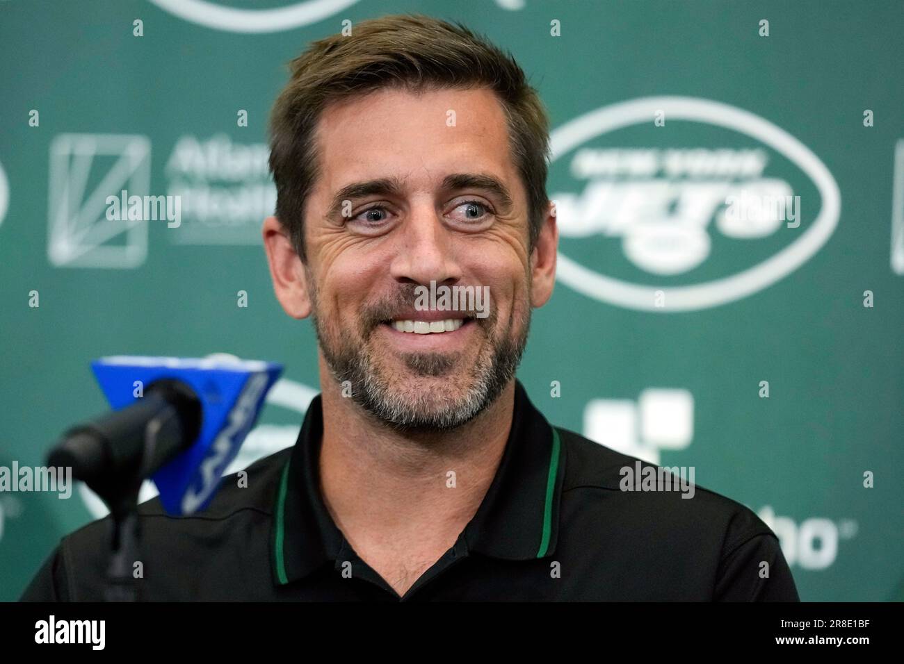 FILE - New York Jets' quarterback Aaron Rodgers smiles during an NFL ...