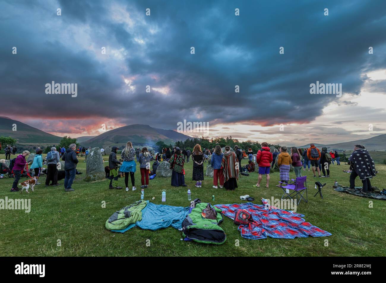 People gather to watch the sun rise during the Castlerigg Stone Circle ...