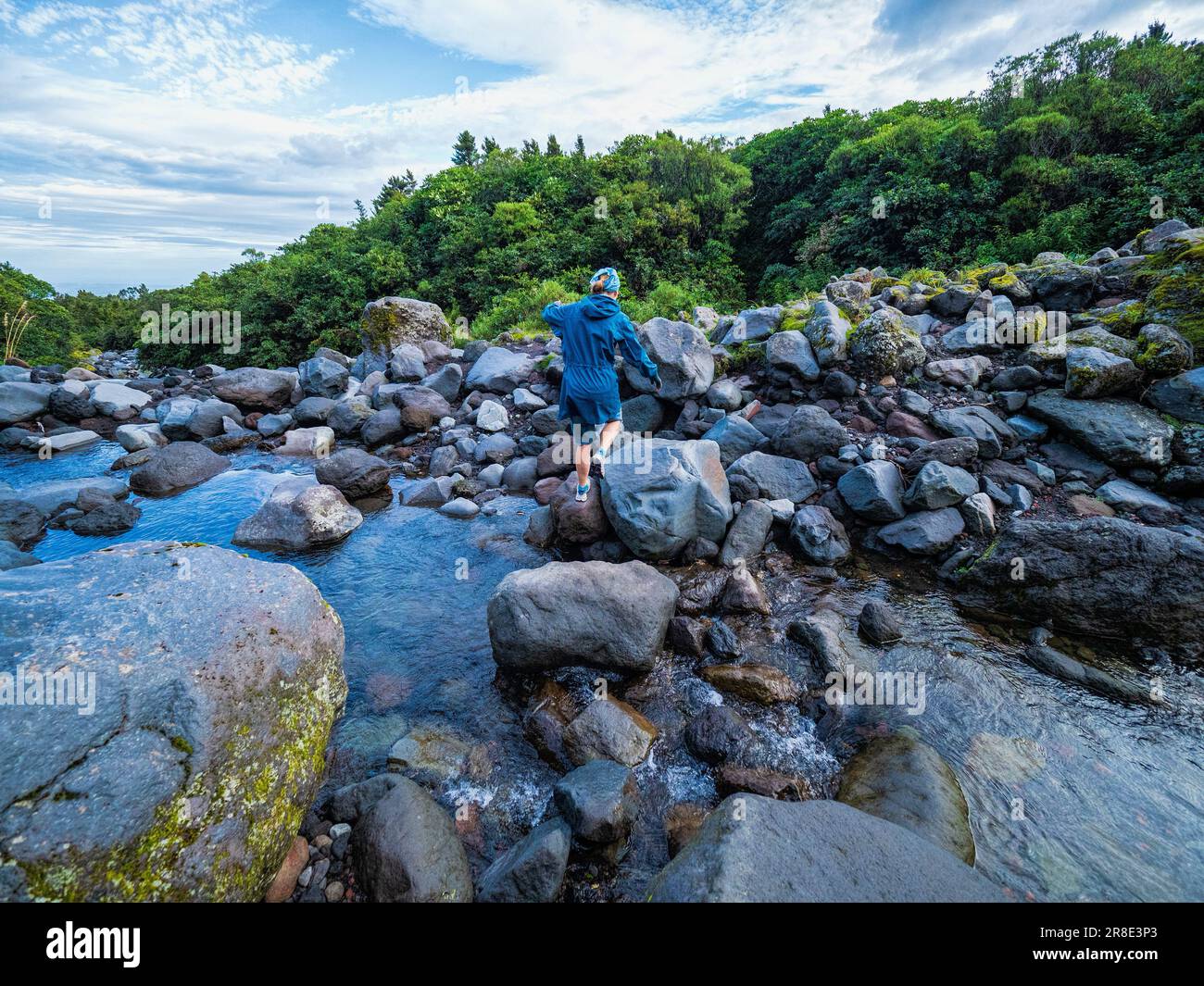 New Zealand, Taranaki, Egmont National Park, Hiker crossing river Stock ...