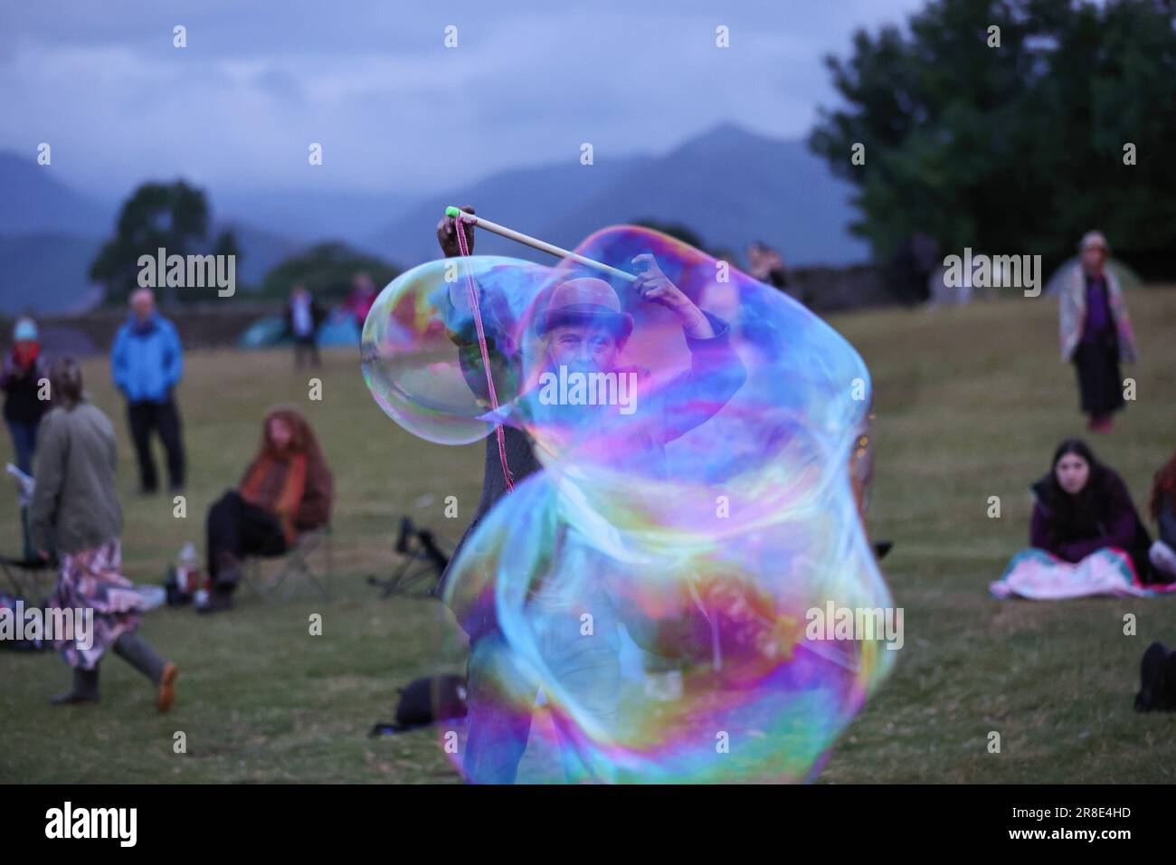 An attendee entertains as he blows giant bubbles during the Castlerigg ...