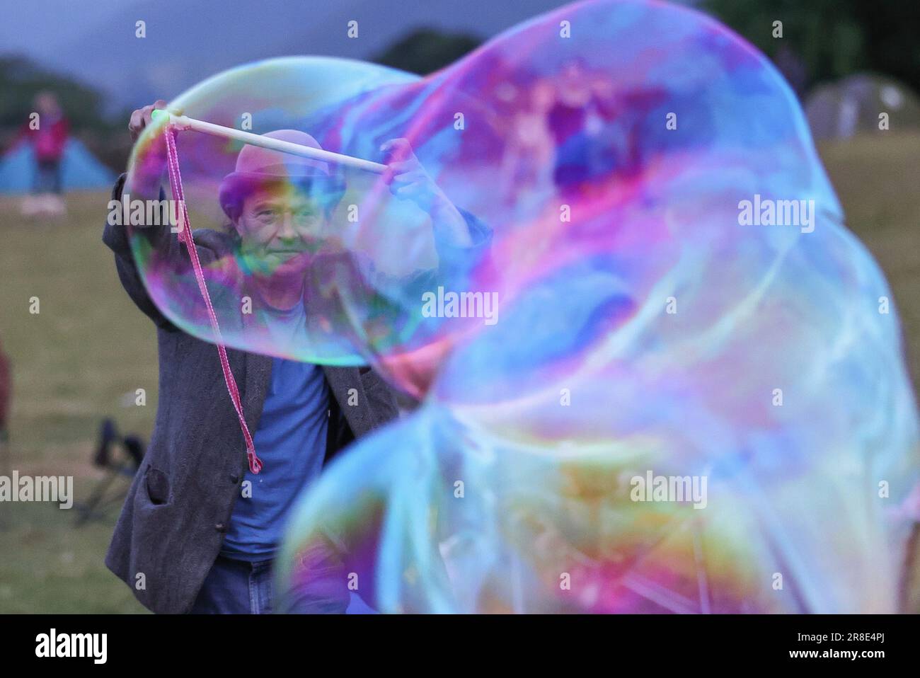 An attendee entertains as he blows giant bubbles during the Castlerigg ...
