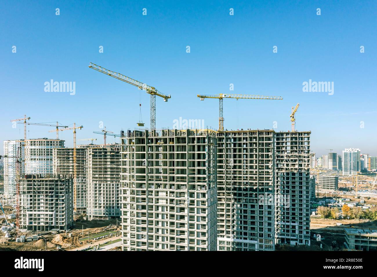 construction site with cranes and apartment buildings under ...