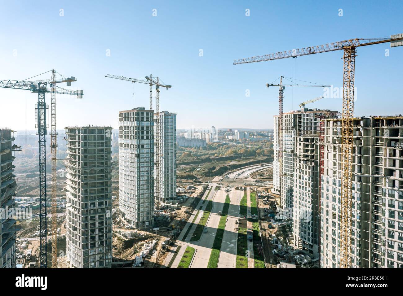aerial view of construction site with cranes and high-rise apartment buildings. top view of big ...