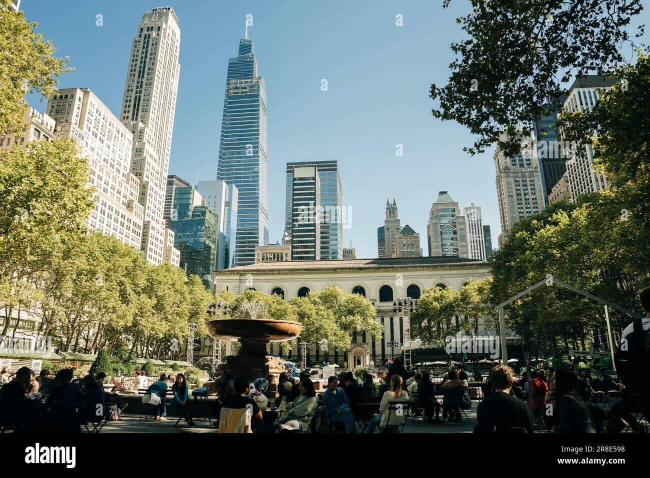 Busy street scene in New York City with groups of people walking across ...
