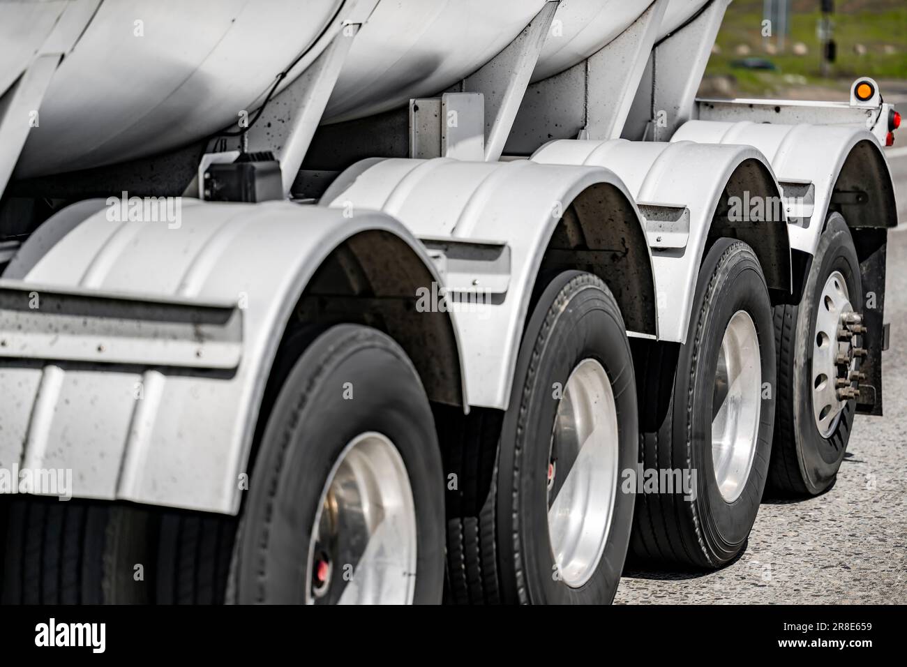 Big rig semi truck transporting heavy loaded tank semi trailer with ...