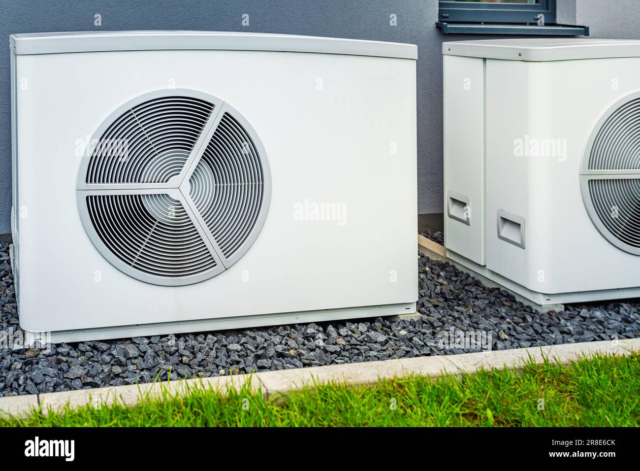 Two air source heat pumps installed outside of new and modern city ...