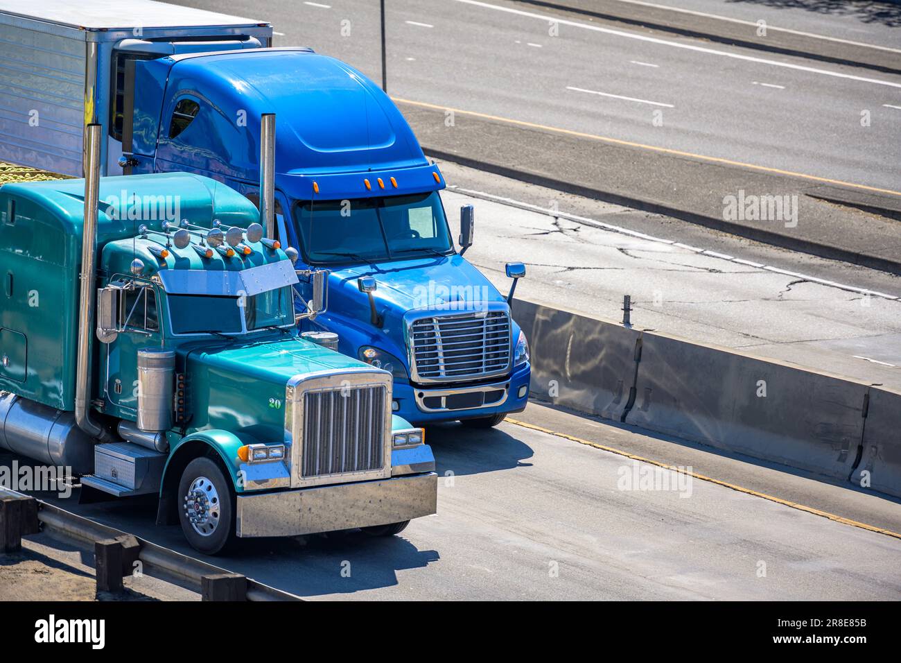 Two industrial big rigs bonnet semi trucks with extended cab ...