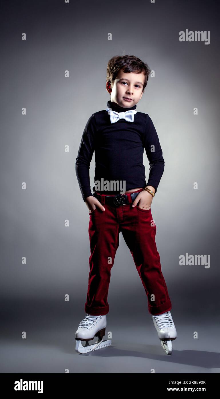 Trendy dressed boy posing ice skating in studio Stock Photo - Alamy
