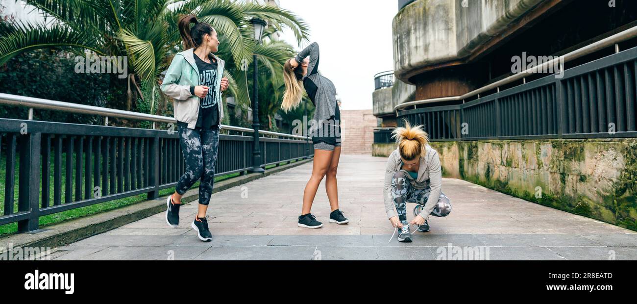 Women runners warming up before running on town Stock Photo - Alamy