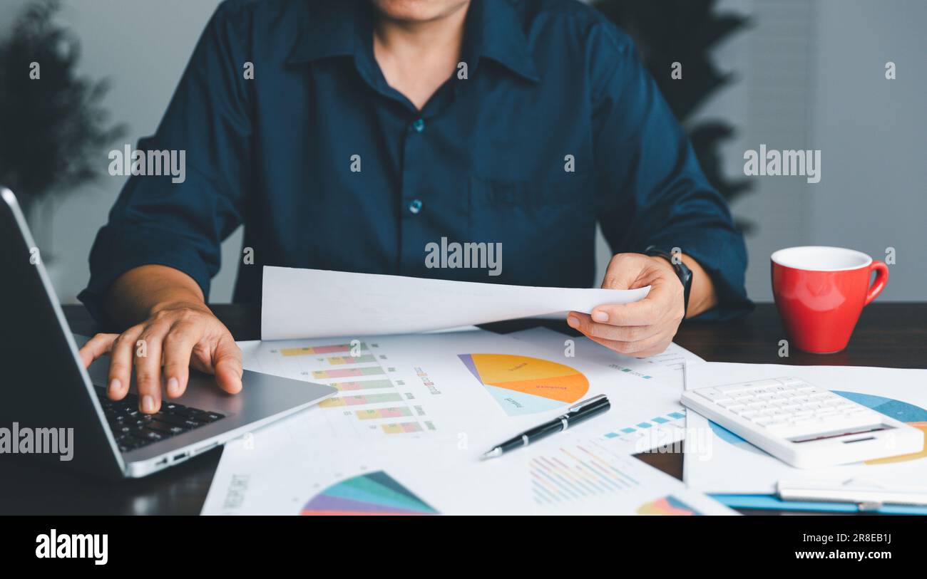 A young female of banking manger using calculator, computer laptop ...