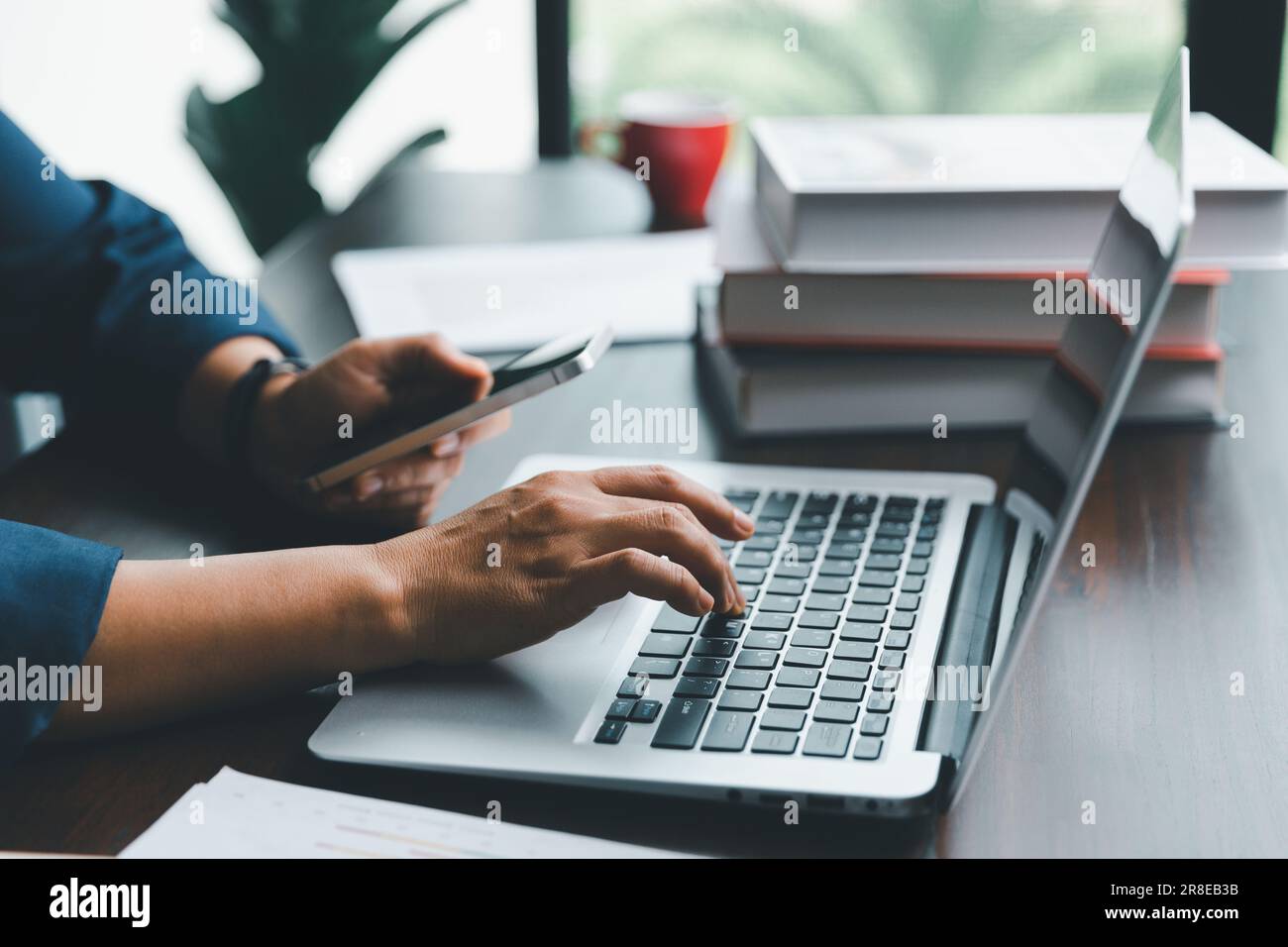 A young female of banking manger using calculator, computer laptop ...