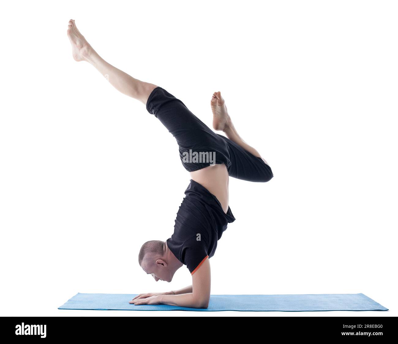 Flexible man posing in difficult yoga pose Stock Photo - Alamy