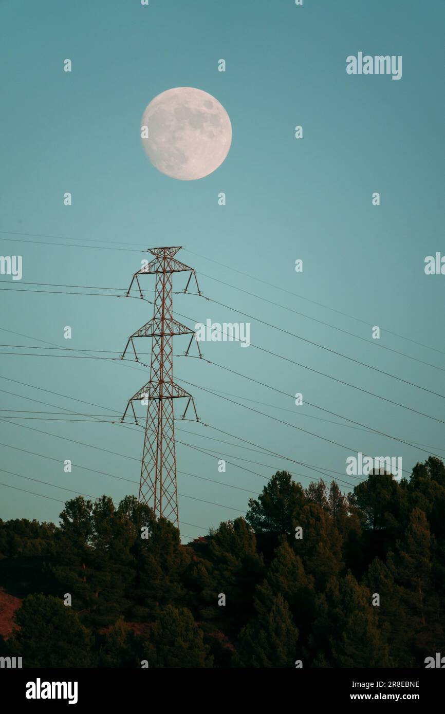 Full Moon over Power Pol and Power lines during golden hour in Spain ...