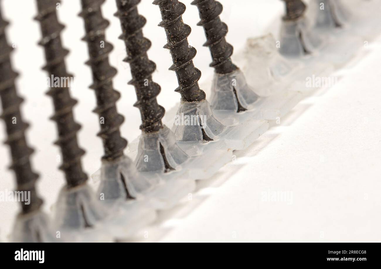Close up view of plastic strip with screws, isolated - Industrial ...