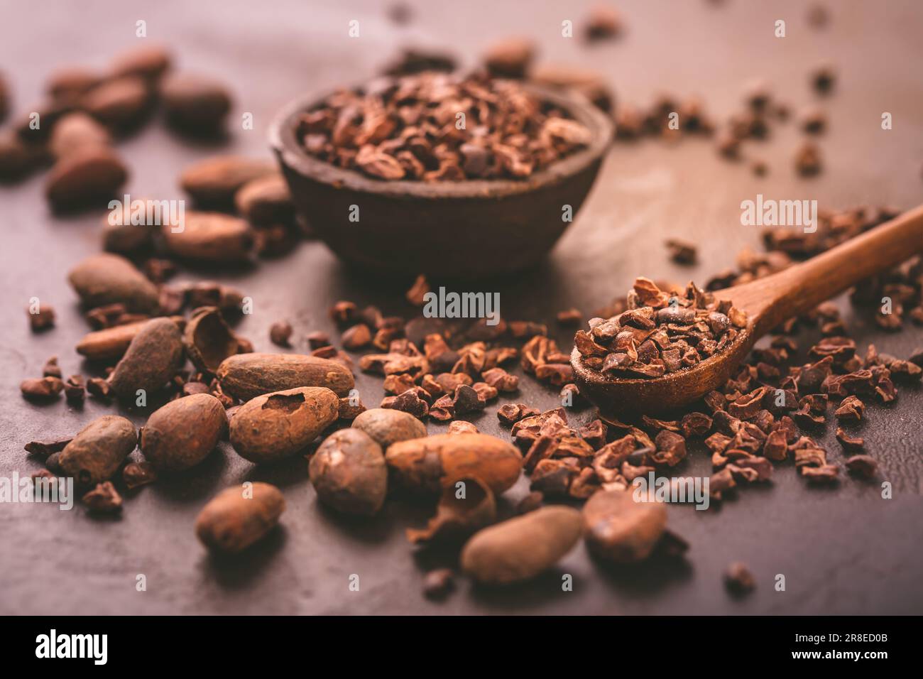 Organic cacao beans and nibs in small bowl Stock Photo - Alamy