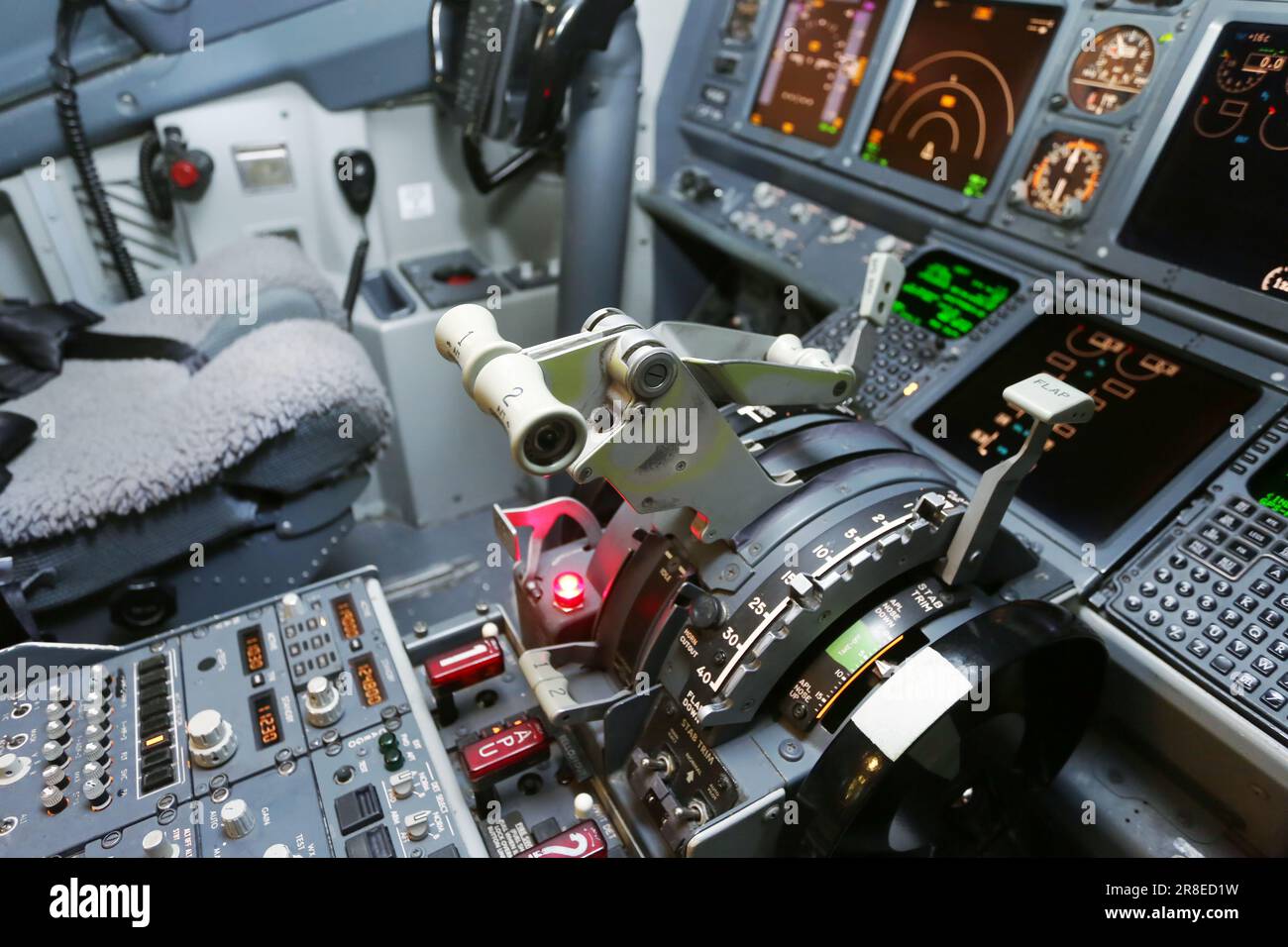 Inside the cockpit of a passenger aircraft. Close-up of thrust levers ...