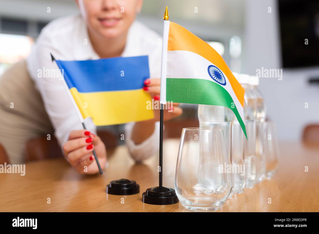 Unrecognizable girl sets midget flags of Ukraine and India before ...