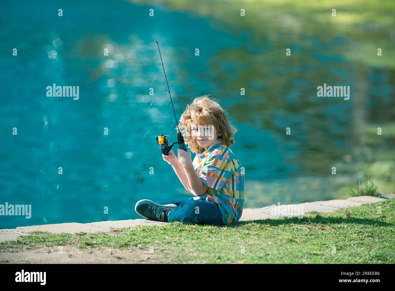 Fishing kid. Boy with spinner at river. Kid at jetty with rod Stock ...