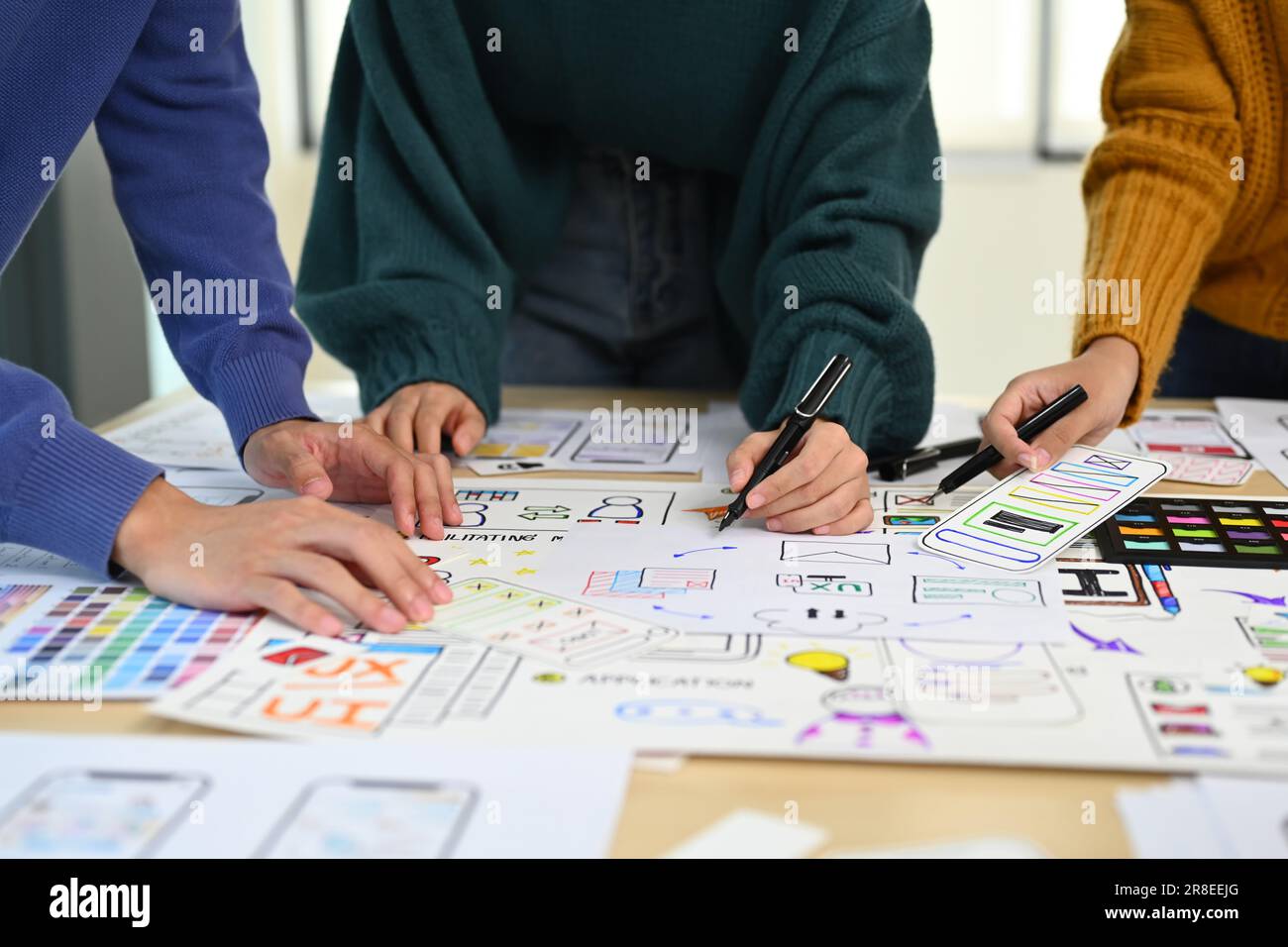 Cropped image of web developer team collaborating and planning template layout for mobile ...