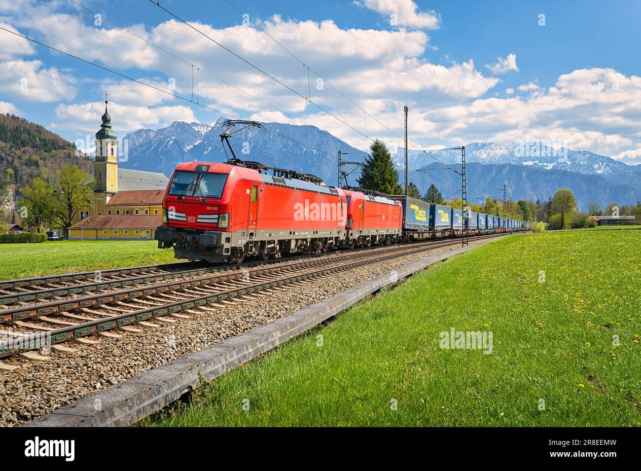 A red train moving along the tracks Stock Photo - Alamy