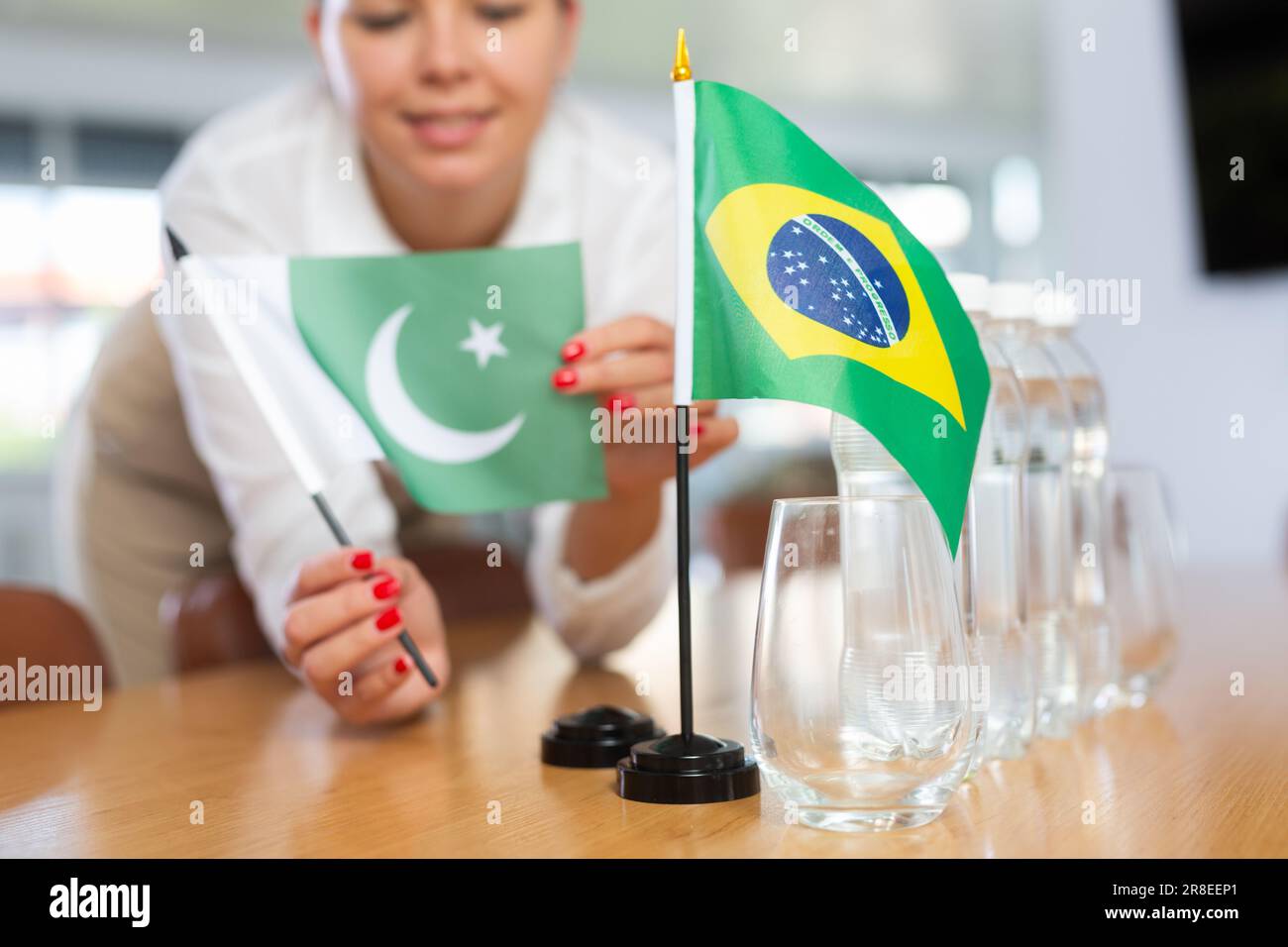 Little flag of Brazil on table and flag of Pakistan put next to it by ...