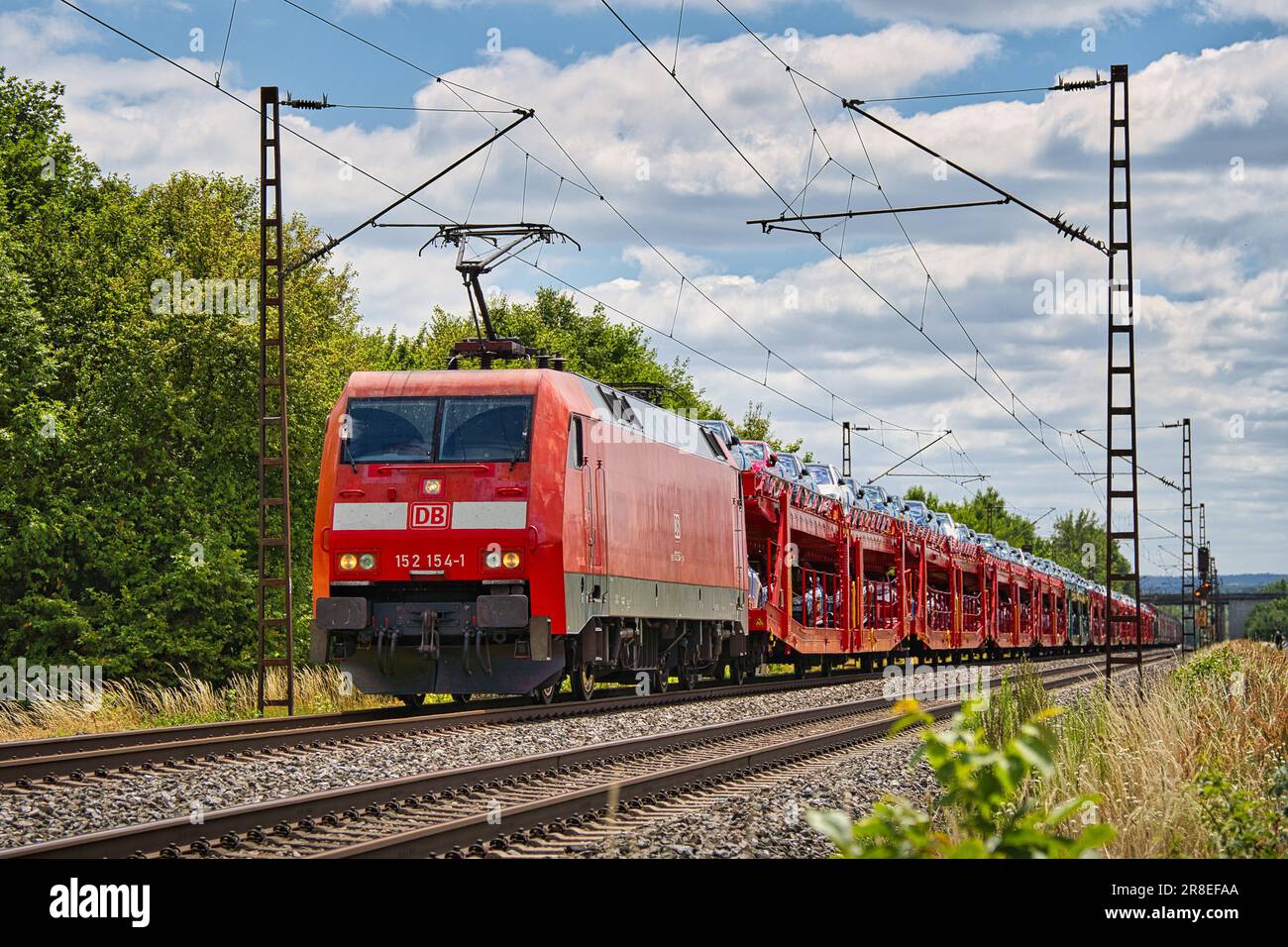 A red train moving along the tracks Stock Photo - Alamy