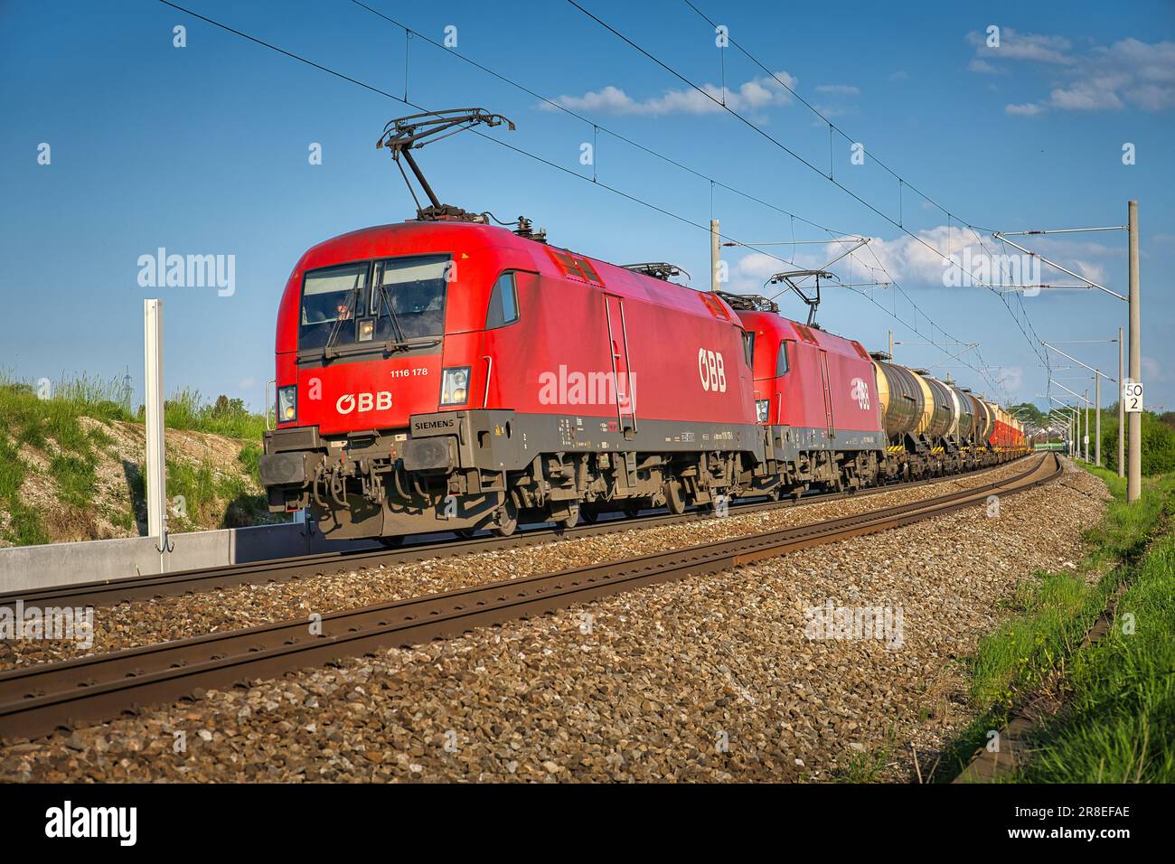 A red train moving along the tracks Stock Photo - Alamy