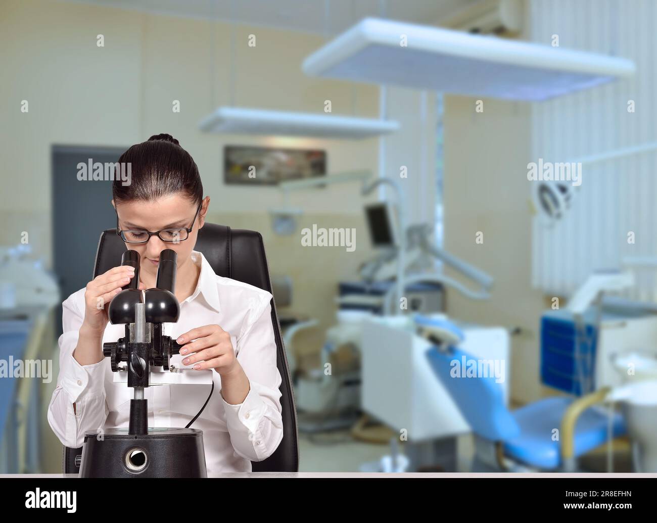 Woman scientist looking through microscope in laboratory Stock Photo ...
