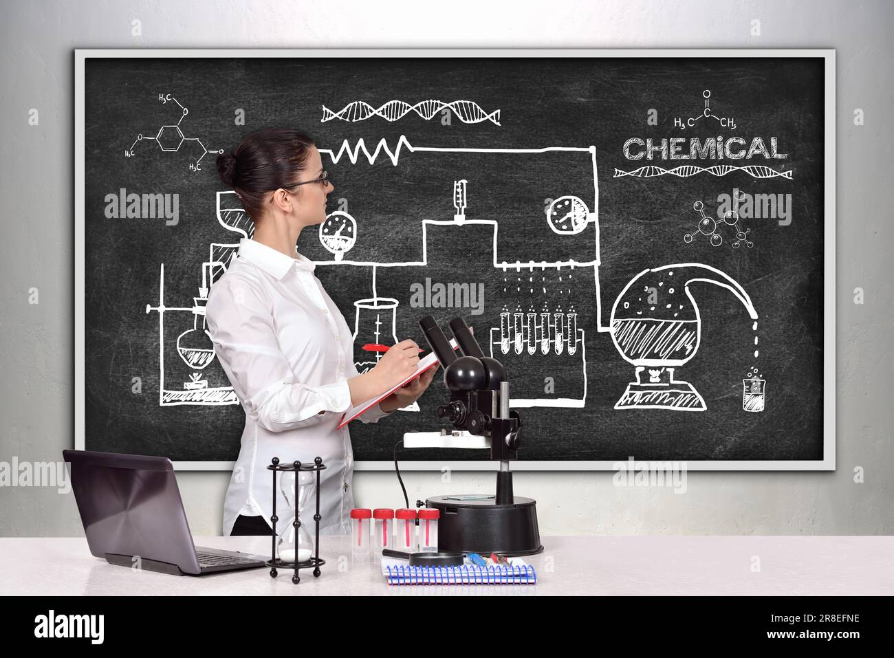 woman scientific researcher in laboratory and looking on blackboard ...