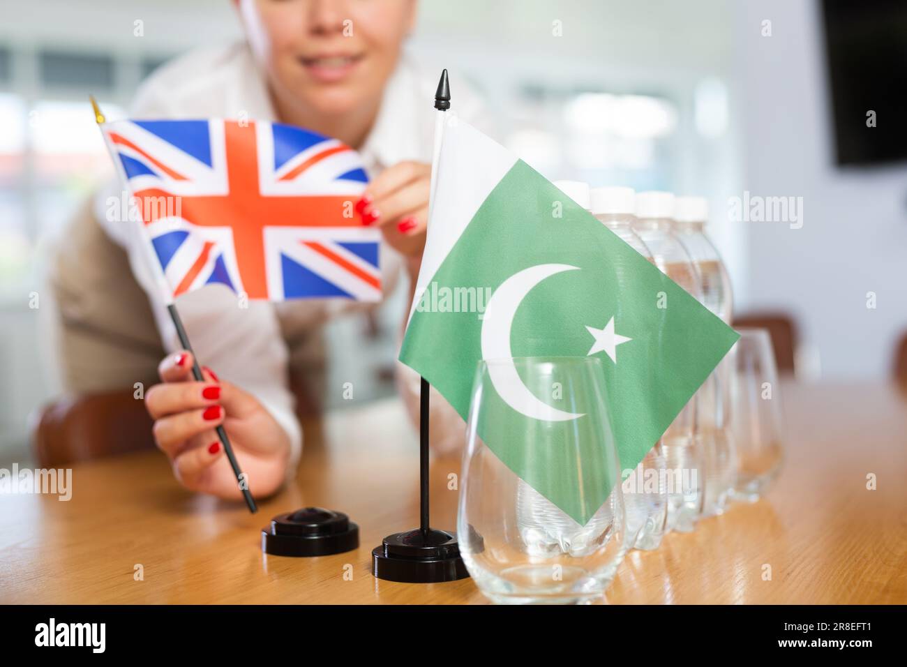 Little flag of Pakistan on table and flag of Great Britain put next to ...