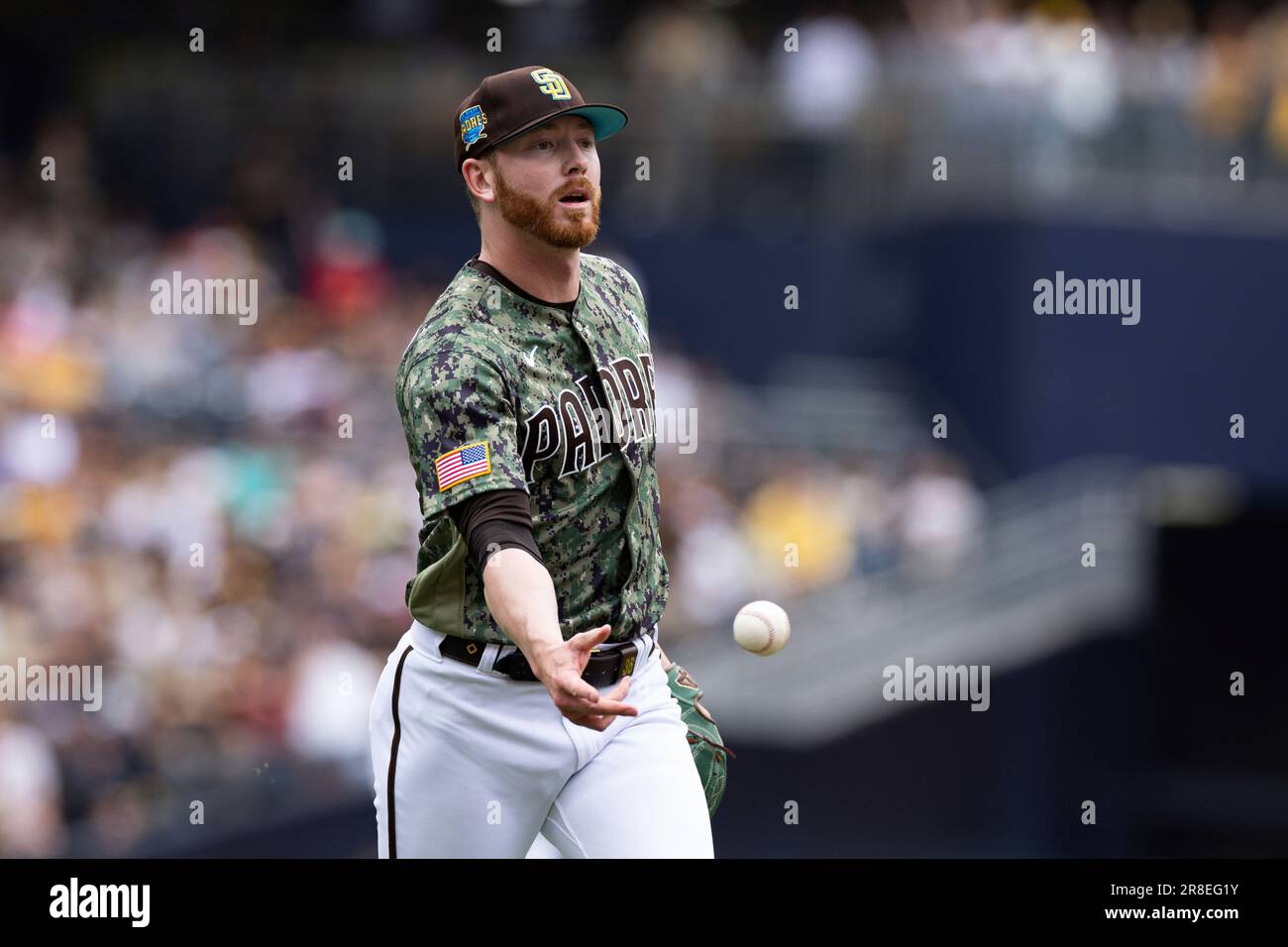 San Diego Padres' Steven Wilson tosses the ball to first base for an ...