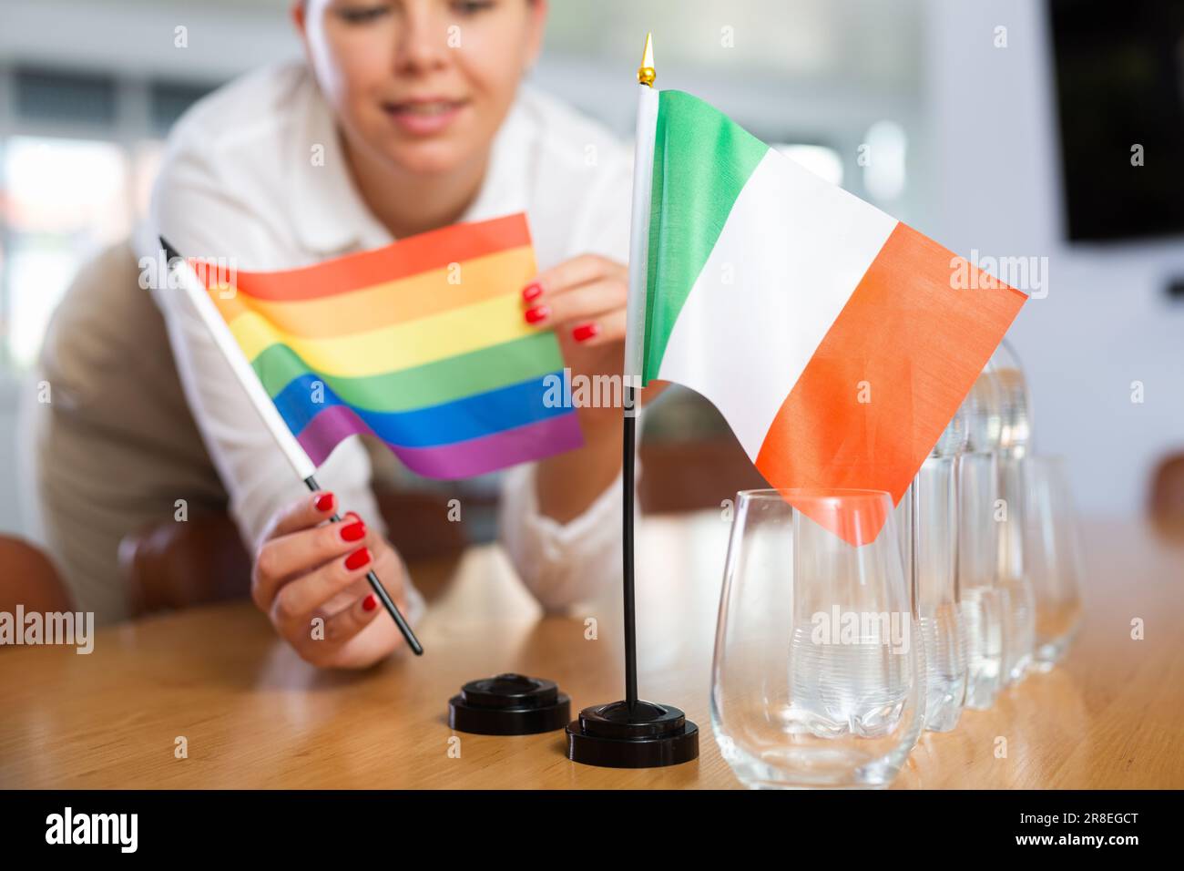 Preparing for business negotiations - woman sets small flags of ...