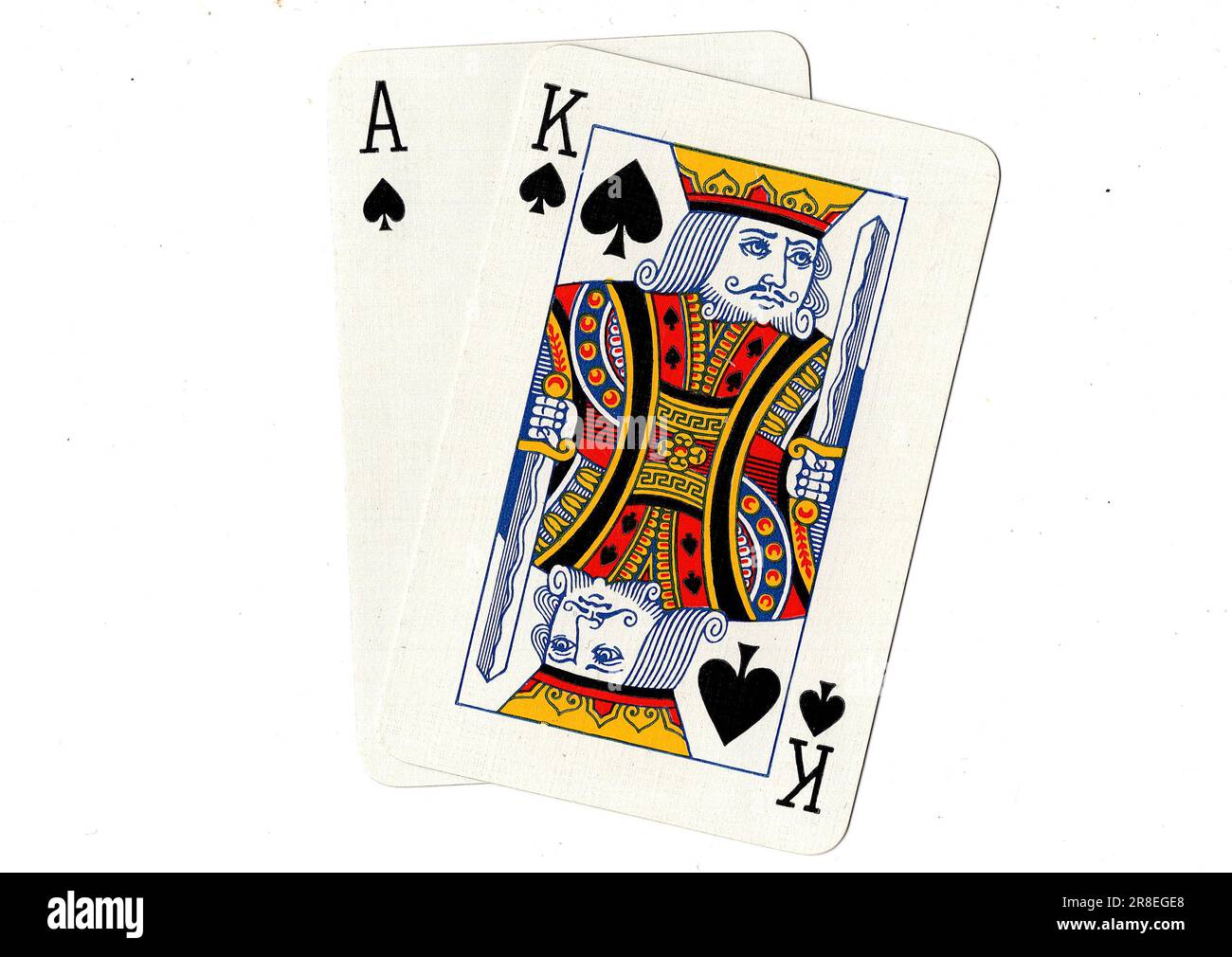 A pair of vintage playing cards featuring a king and ace of spades on a ...