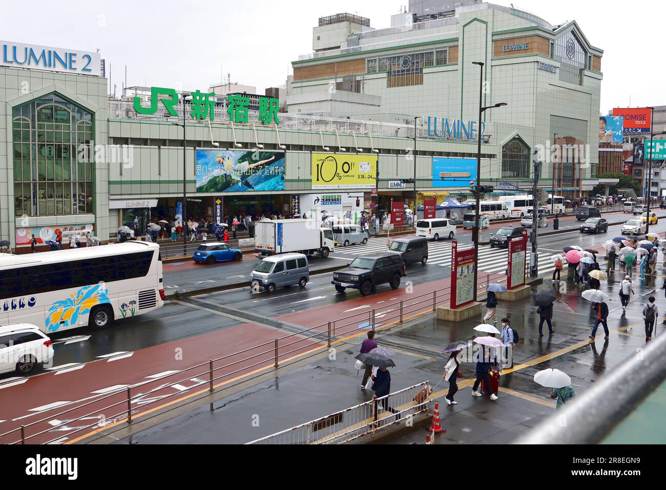 Shinjuku Ward, Tokyo, May 2023.People with umbrellas at the south exit ...