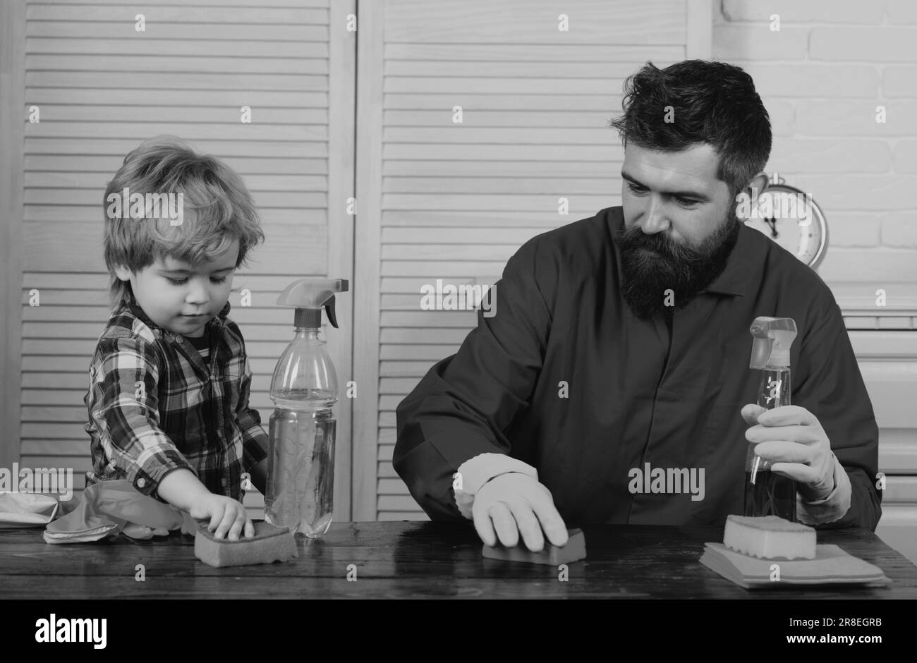 Man cleaning house together at home. Father and son with clean supplies ...