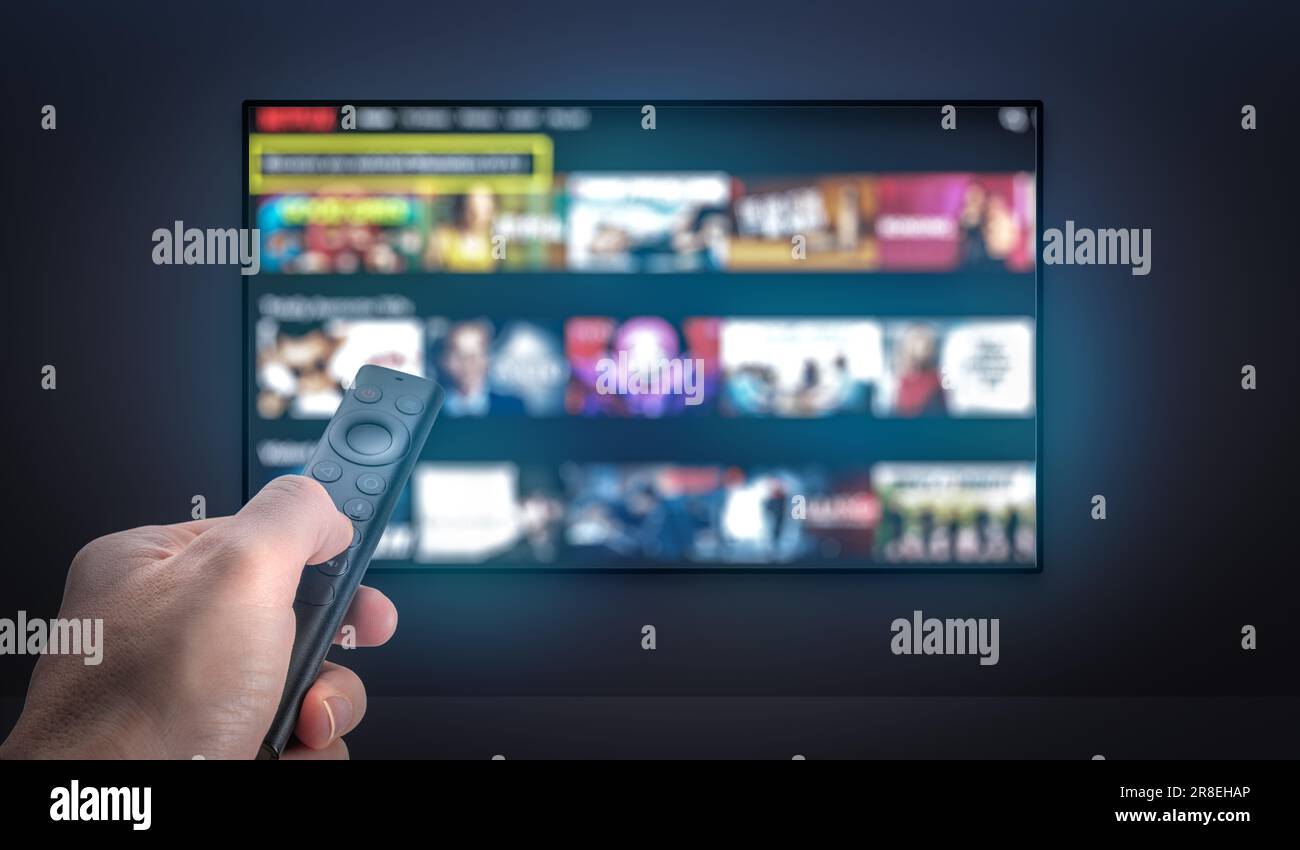 Streaming service. TV screen with lot of pictures and hand holding TV ...
