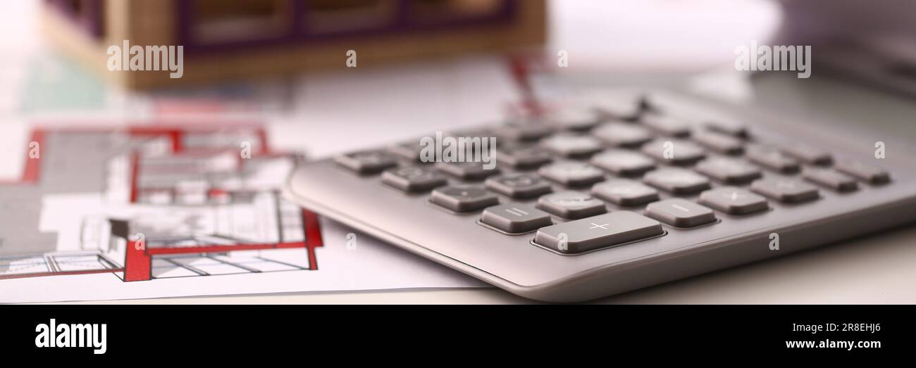 Architectural house plan house layout and calculator on table Stock ...