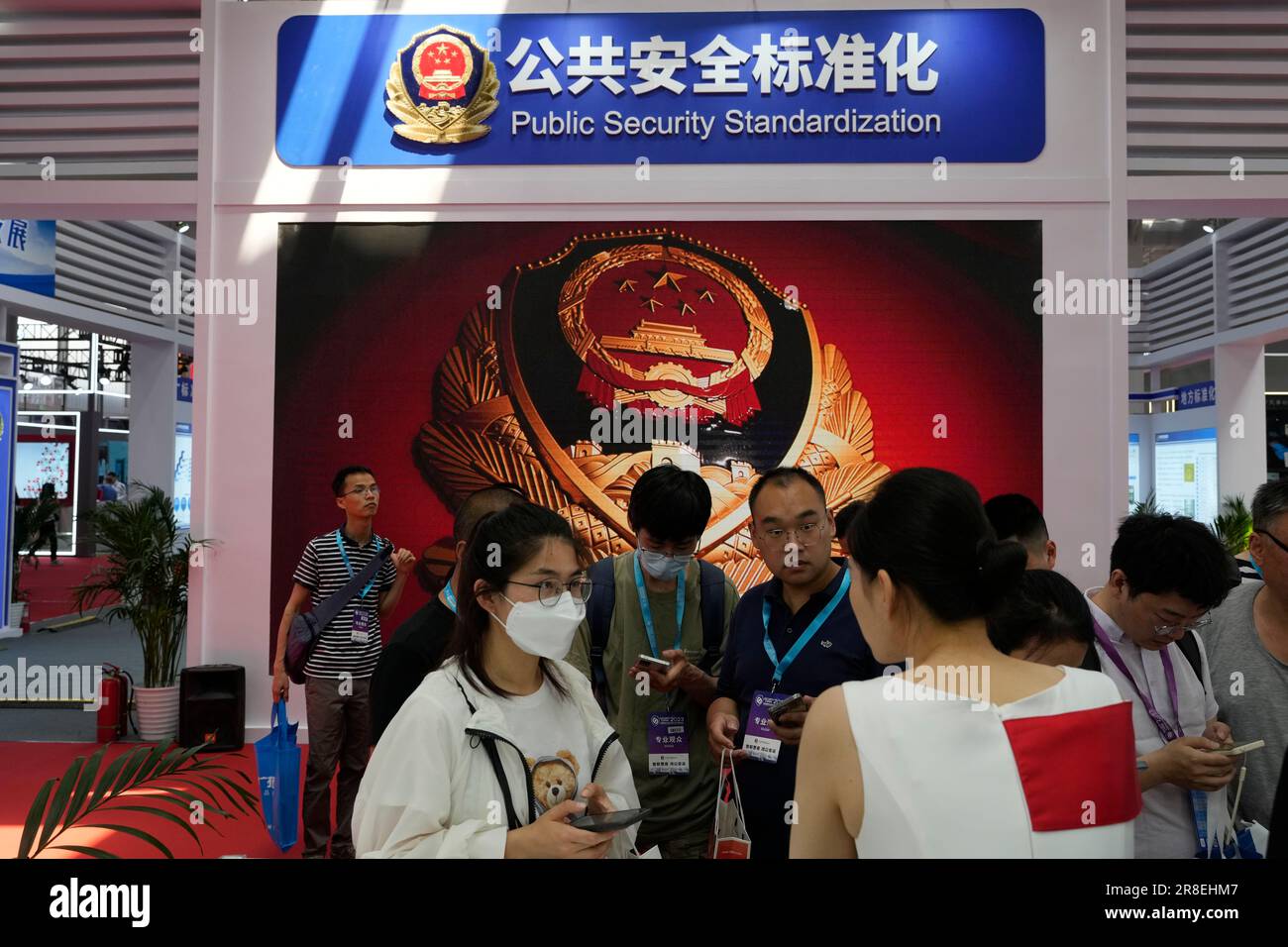 Visitors pass near the booth for the Chinese police department setting ...