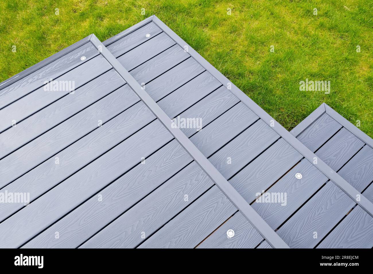 Ash grey composite decking on a rainy wet day showing the full grain of ...