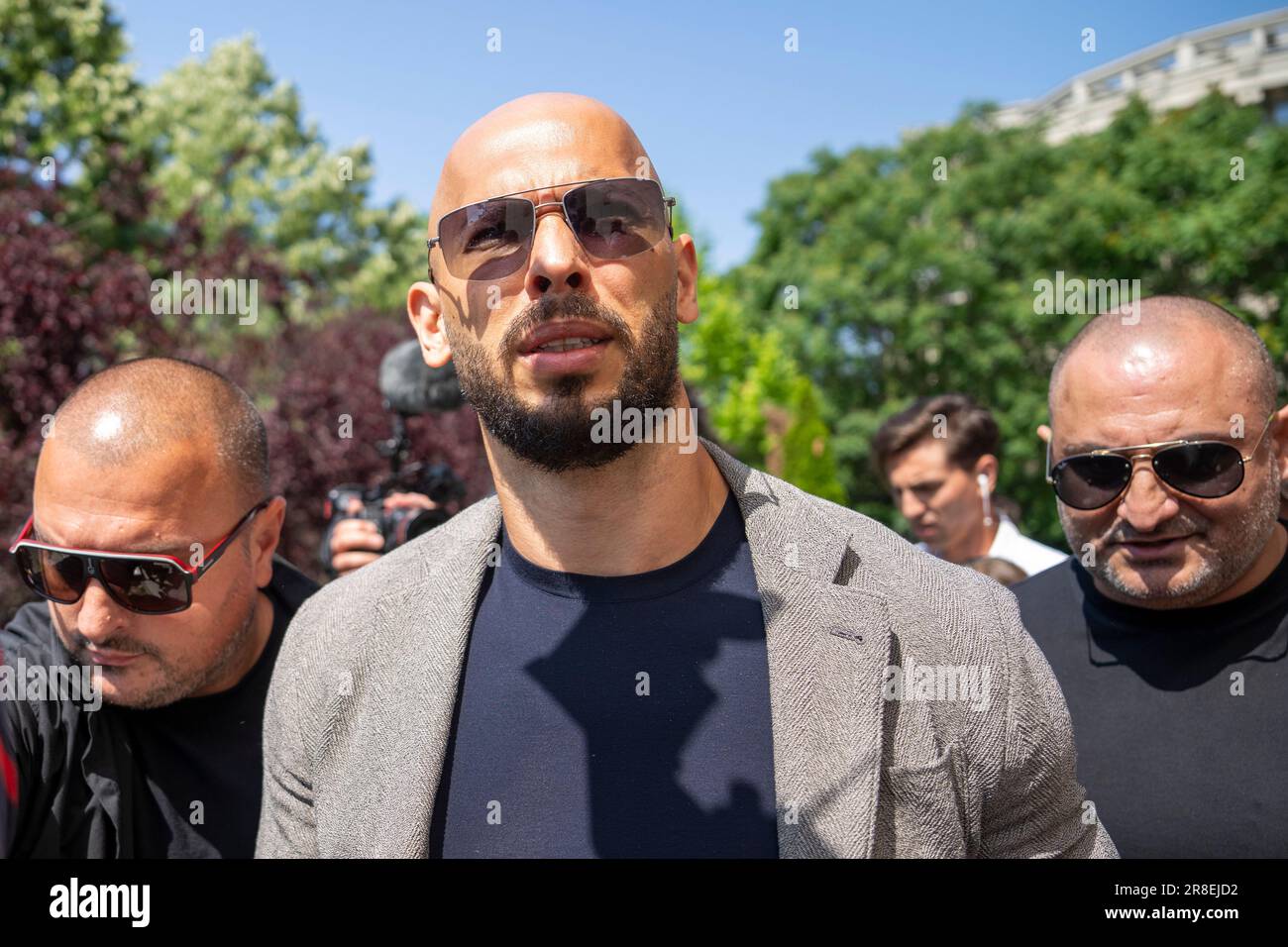 Andrew Tate walks between bodyguards as he arrives at the Bucharest ...