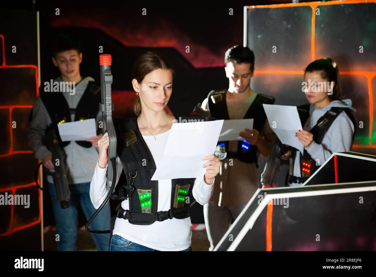 Group of laser tag players read a contract and game conditions Stock ...
