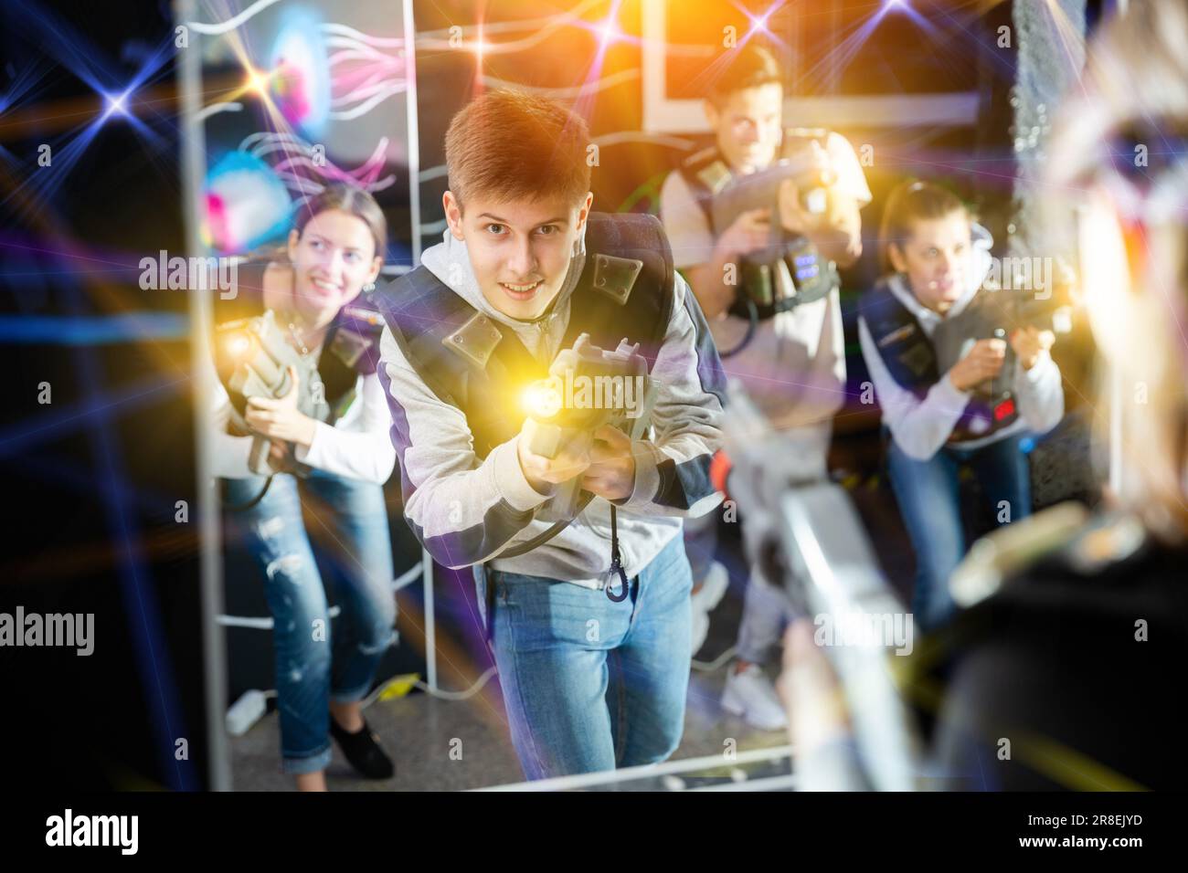 Excited guy laser tag player in bright beams Stock Photo - Alamy
